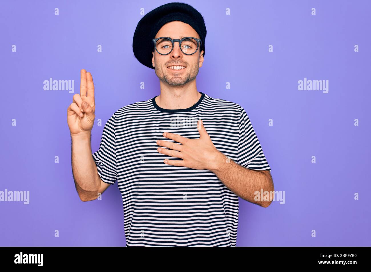 Handsome man with blue eyes wearing striped t-shirt and french beret ...