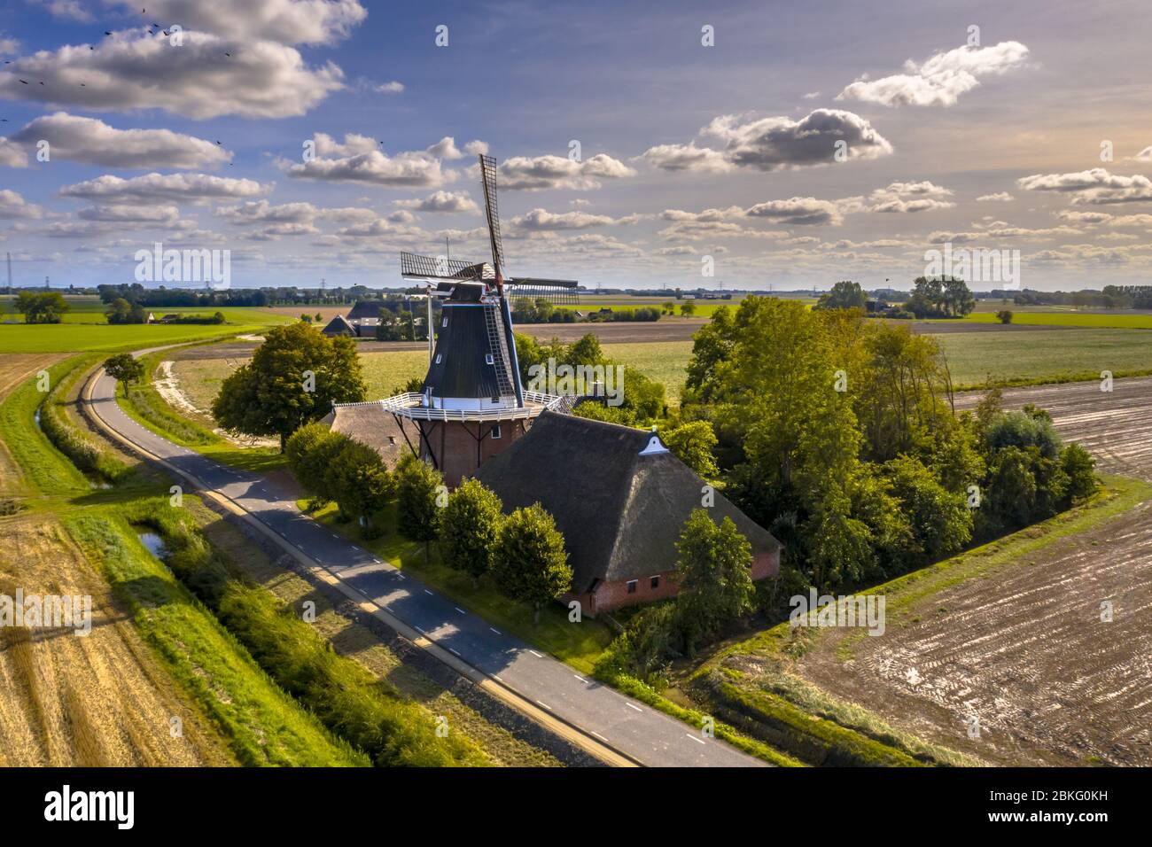 Aerial view of small dutch hamlet with historic wooden windmill in ...