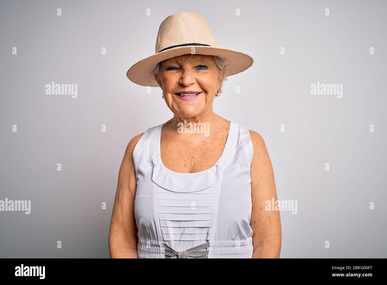 Senior beautiful grey-haired woman on vacation wearing casual summer ...