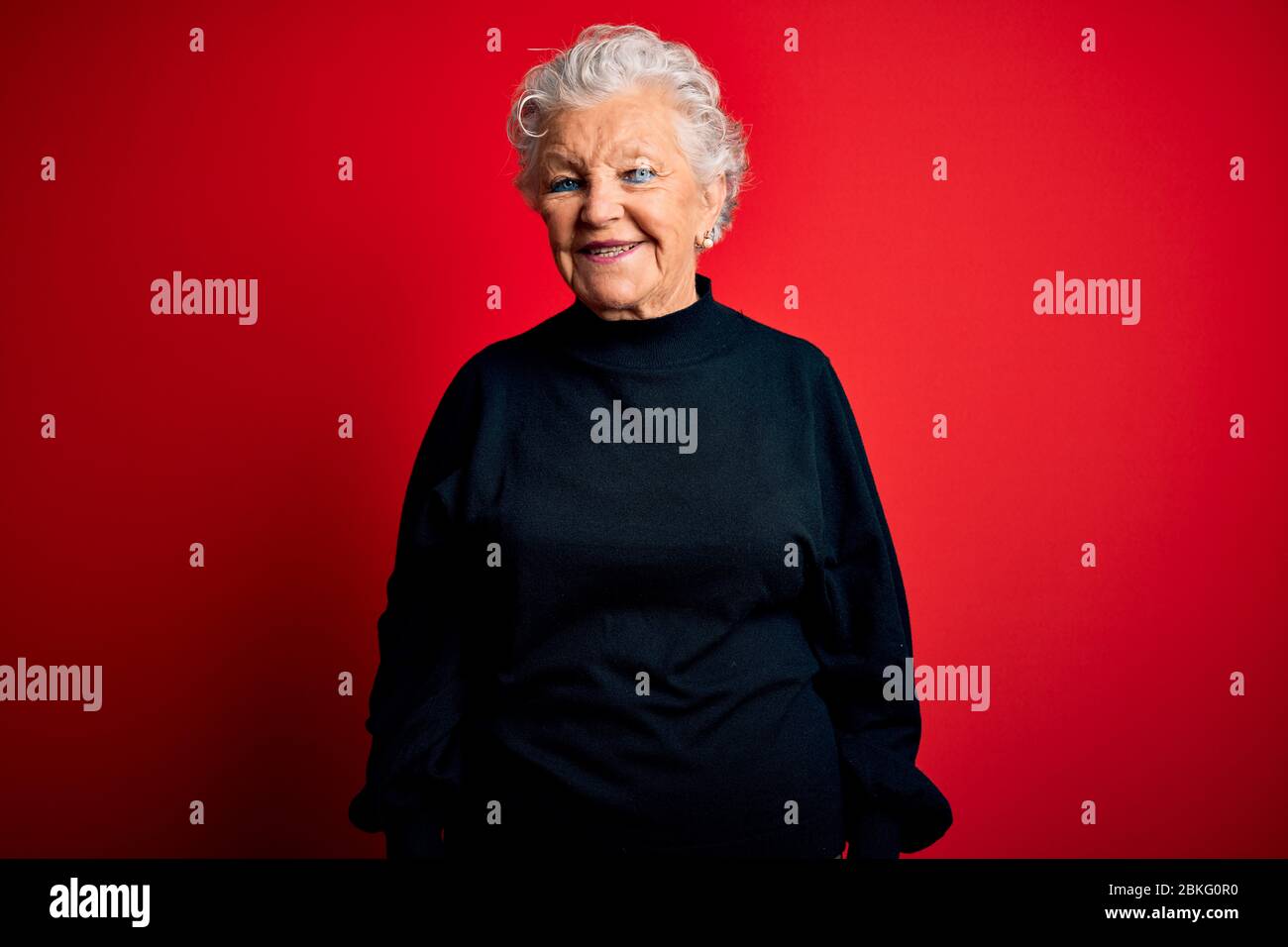 Senior beautiful woman wearing casual sweater standing over isolated ...
