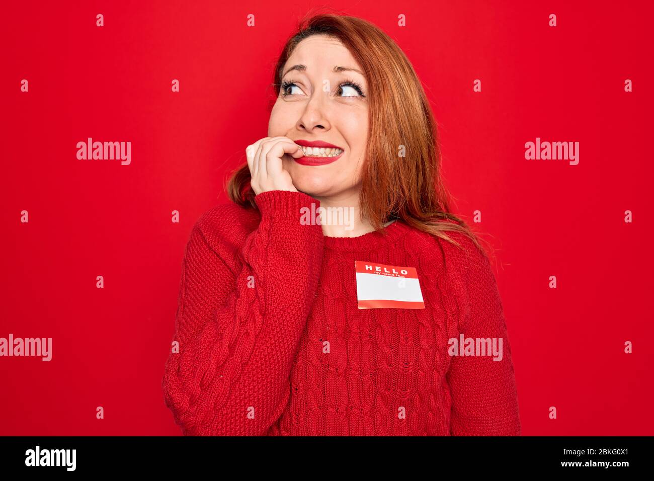 Young beautiful redhead woman wearing sticker presentation with hello ...