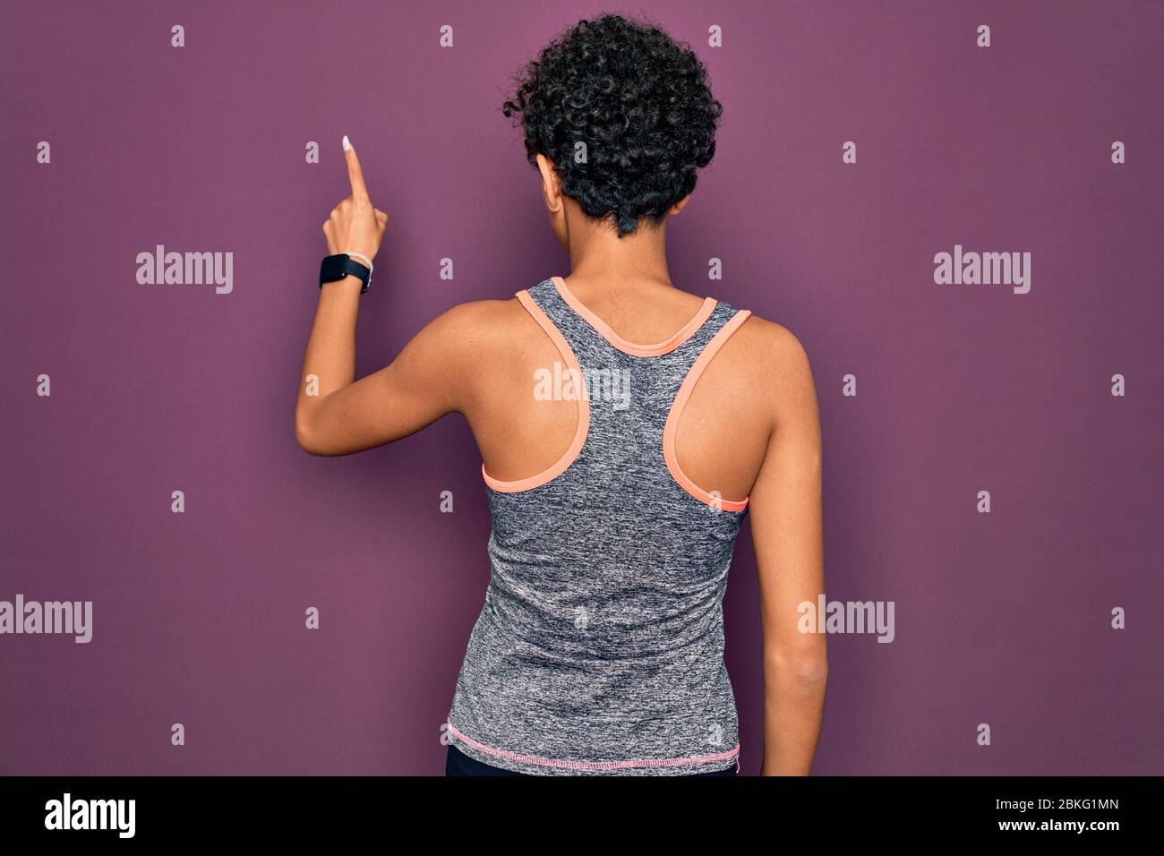 Young beautiful african american afro sportswoman doing exercise ...