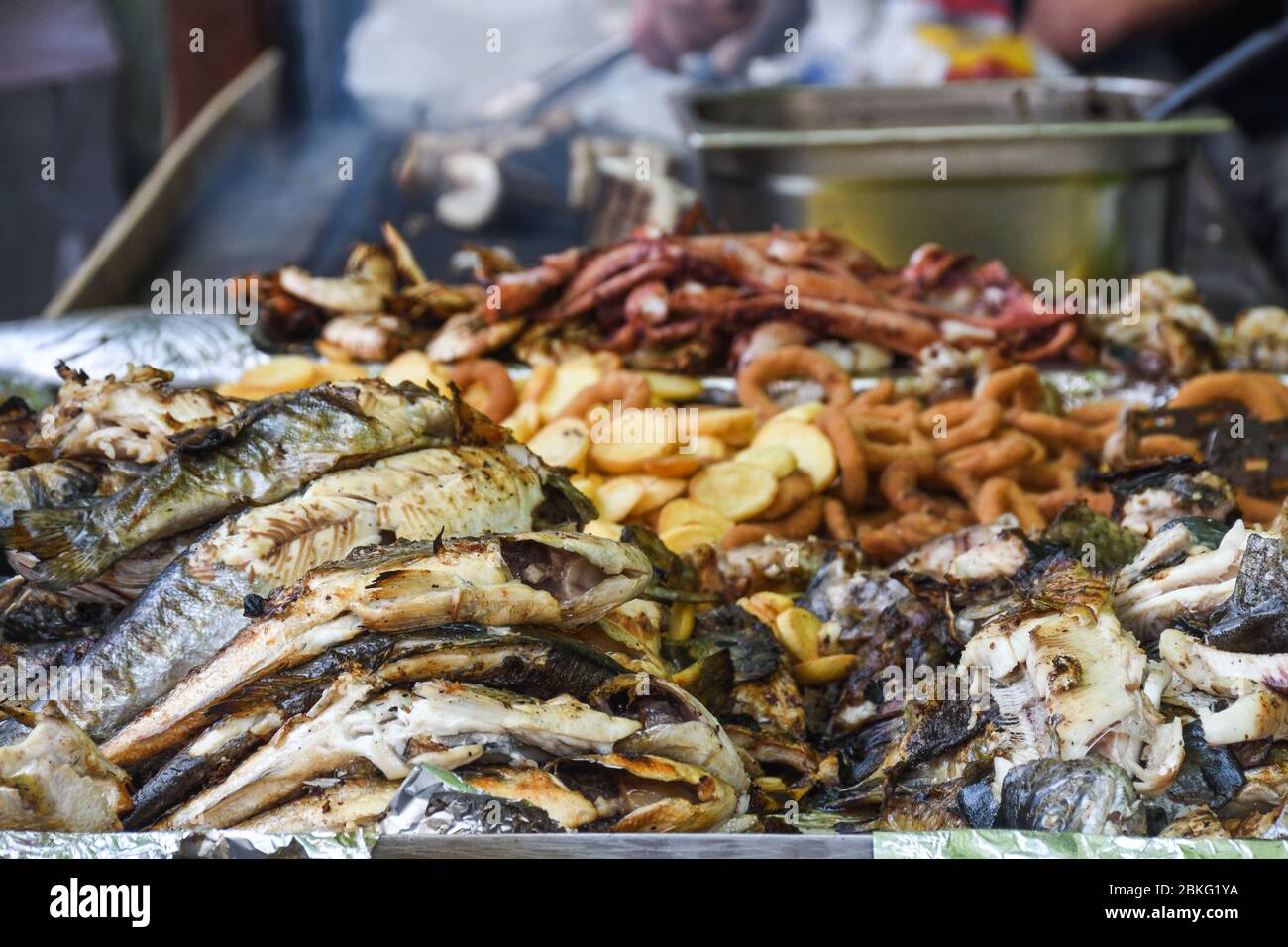 Freshly grilled fish on counter top stall, during seafood festival ...