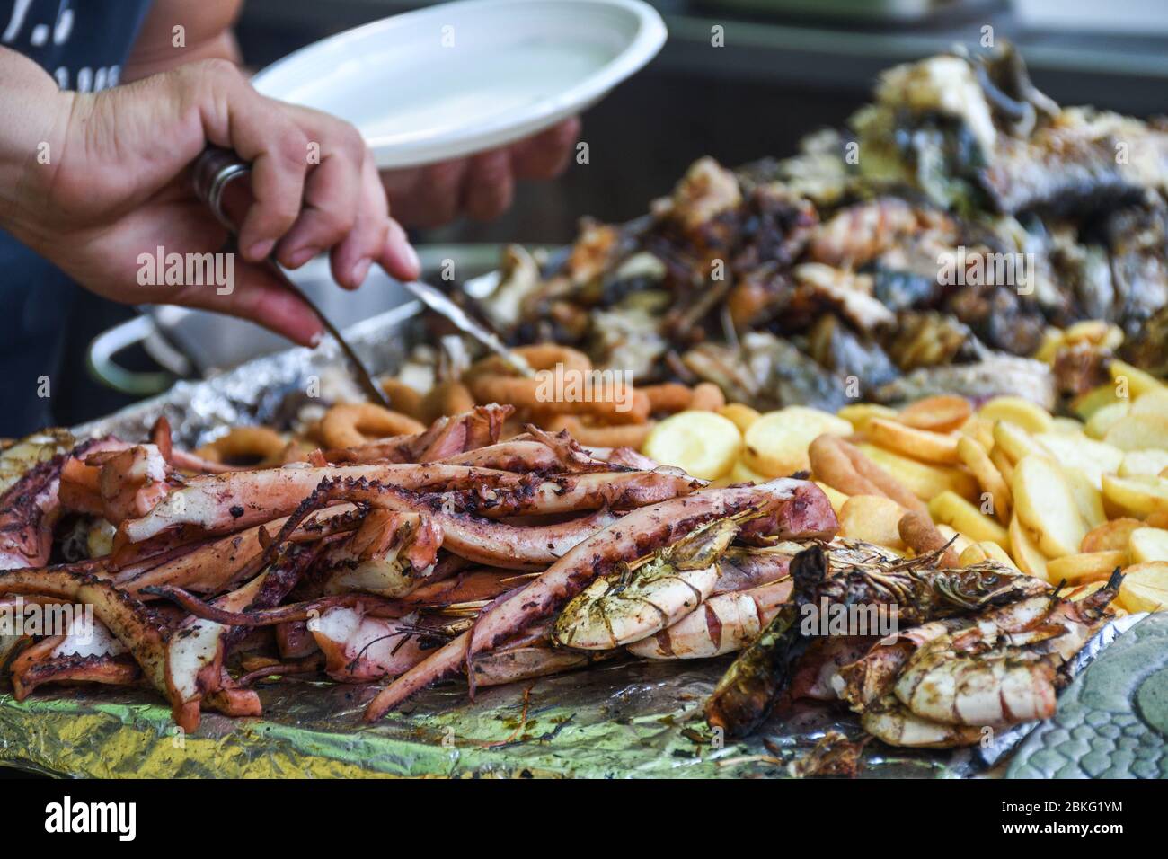 Freshly grilled fish on counter top stall, during seafood festival ...