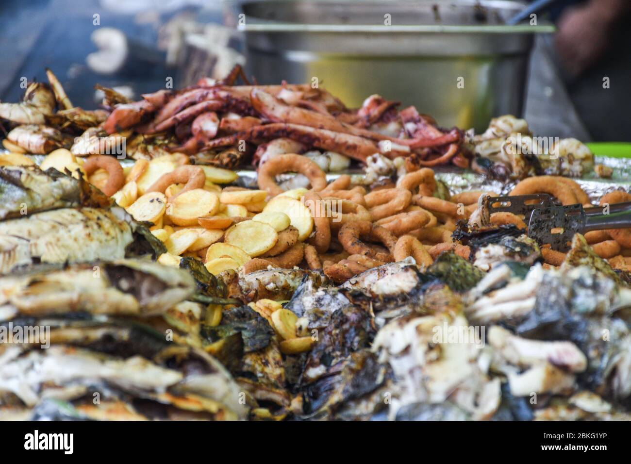 Freshly grilled fish on counter top stall, during seafood festival ...