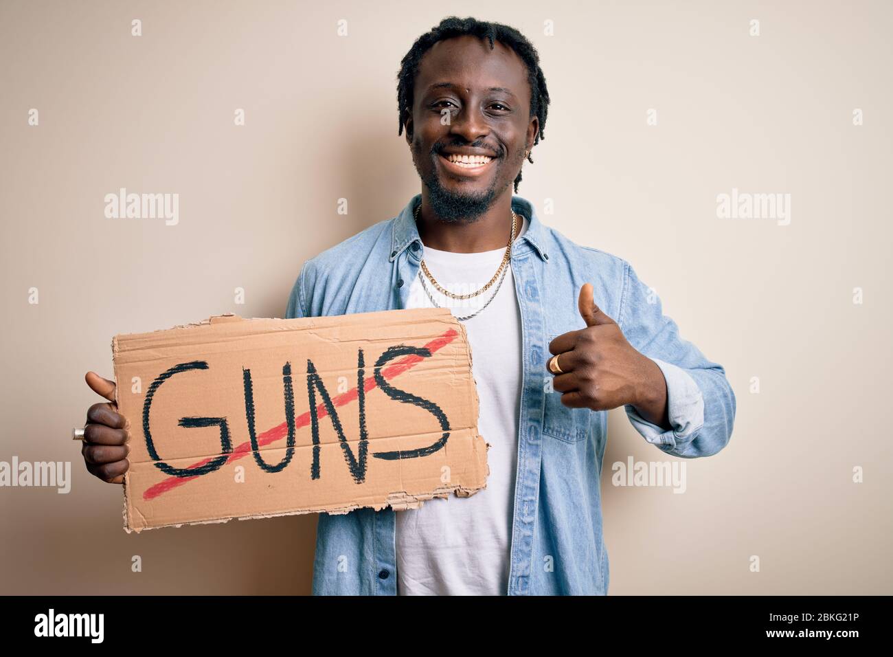 Young african american man asking for peace holding banner with ...