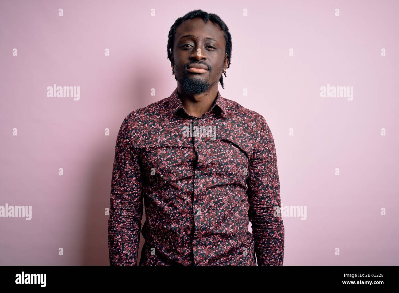 Young handsome african american man wearing casual shirt standing over ...