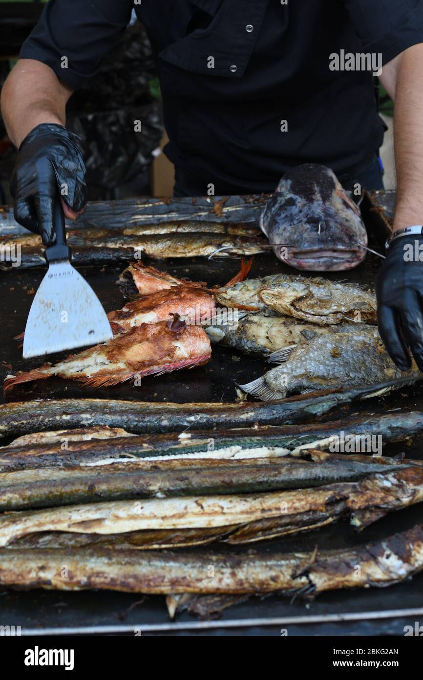 Freshly grilled fish on counter top stall, during seafood festival ...