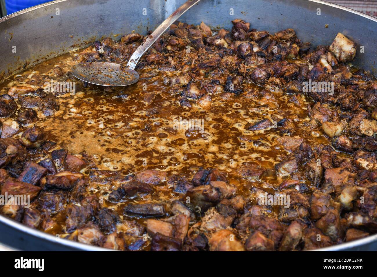 Traditional fish stew being prepared in a rustic bowl over a wood ...