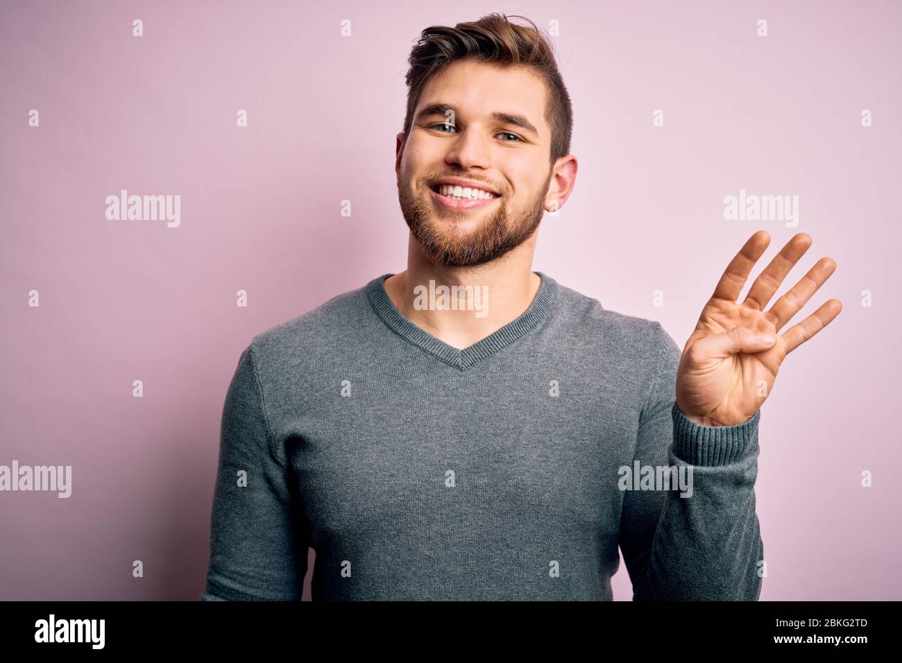 Young handsome blond man with beard and blue eyes wearing casual ...