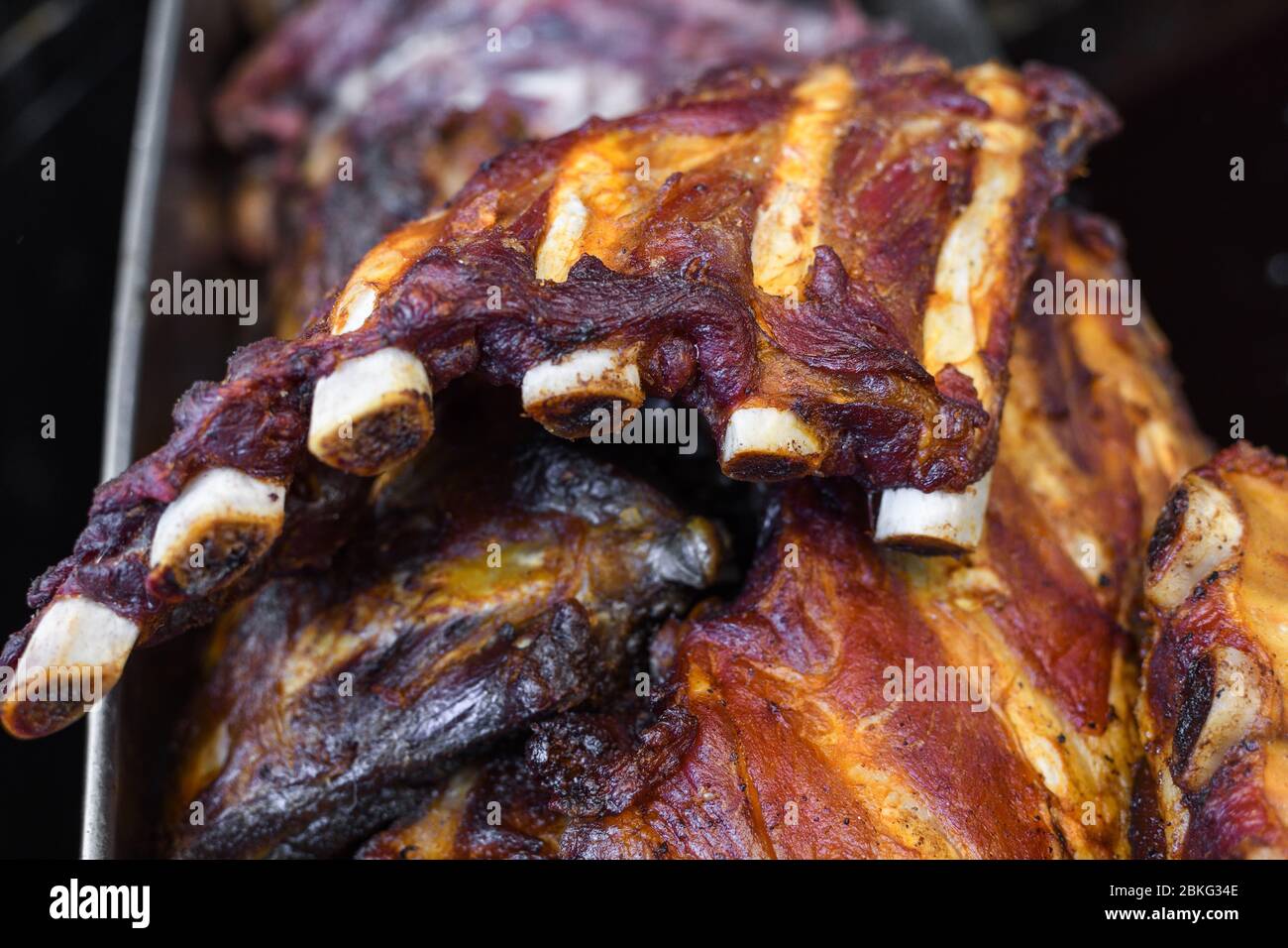 Marinated pork spare ribs, stack or pile of fresh grilled meat during ...