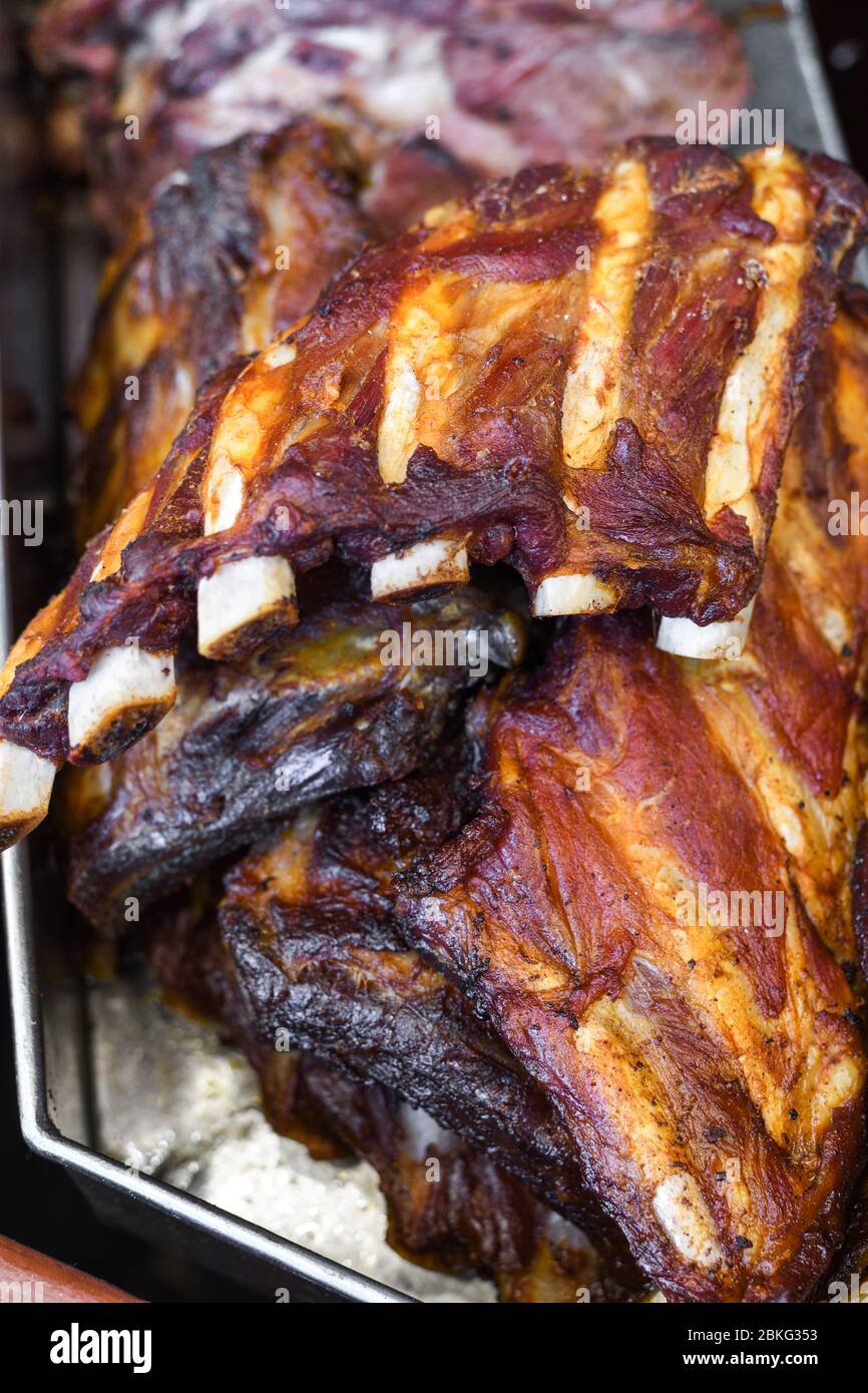 Marinated pork spare ribs, stack or pile of fresh grilled meat during ...