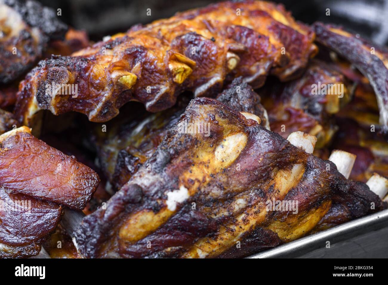 Marinated pork spare ribs, stack or pile of fresh grilled meat during ...