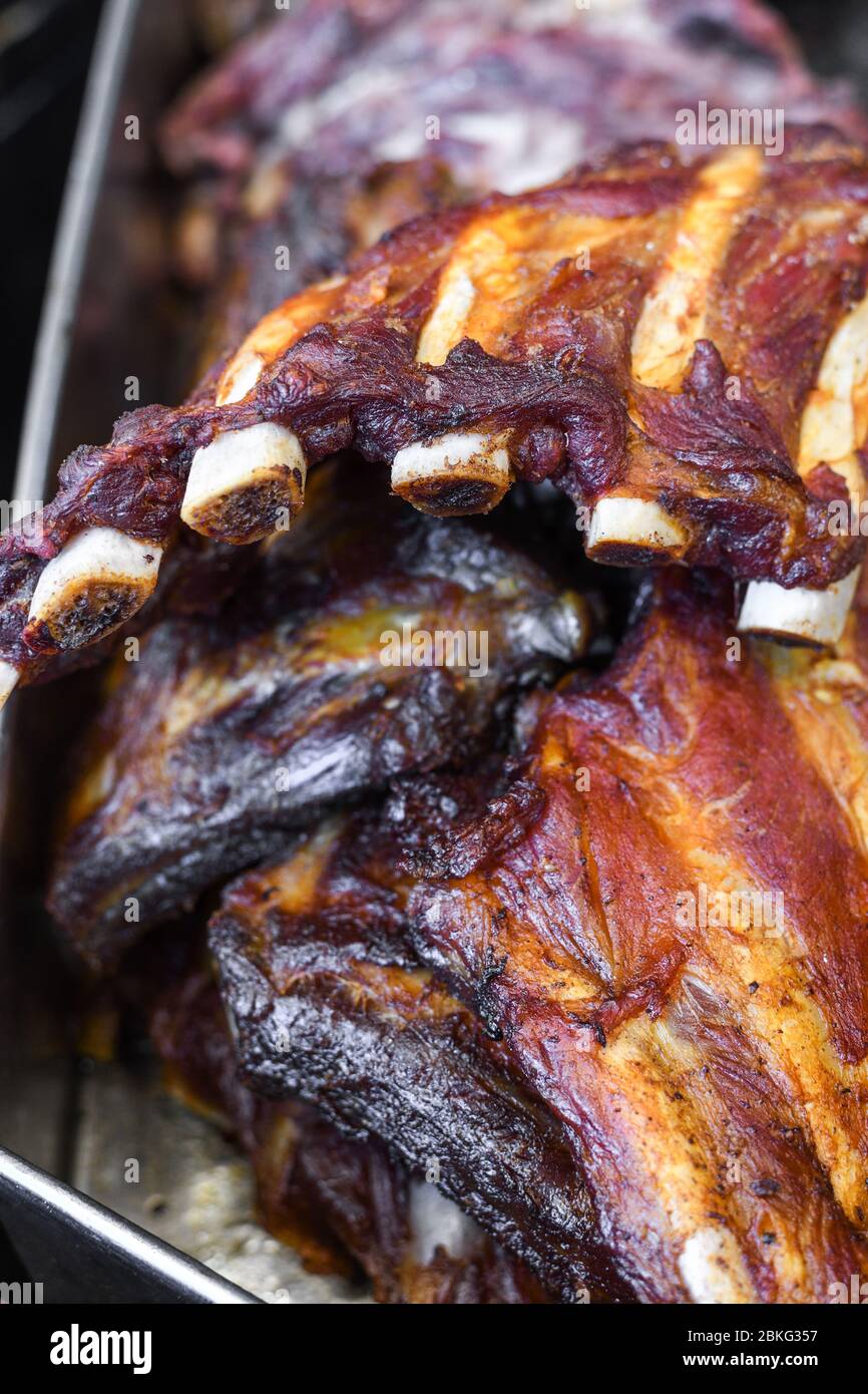 Marinated pork spare ribs, stack or pile of fresh grilled meat during ...