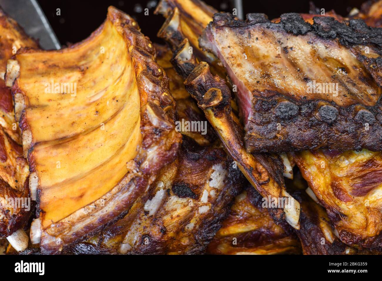 Marinated pork spare ribs, stack or pile of fresh grilled meat during ...