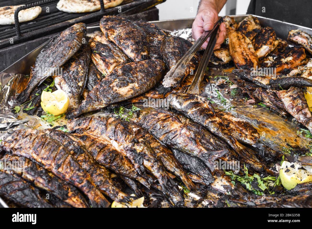 Freshly grilled fish on counter top stall, during seafood festival ...