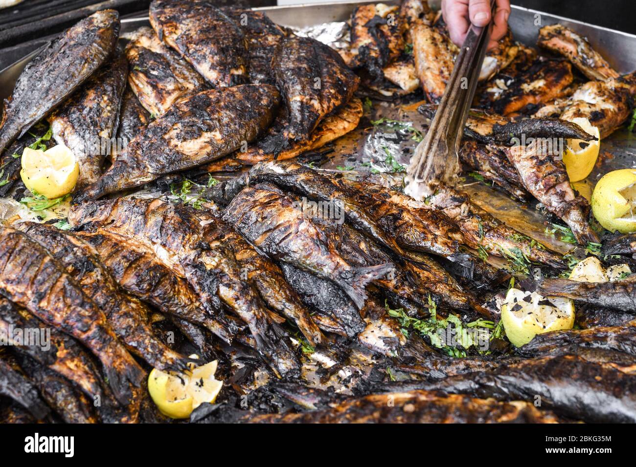 Freshly grilled fish on counter top stall, during seafood festival ...