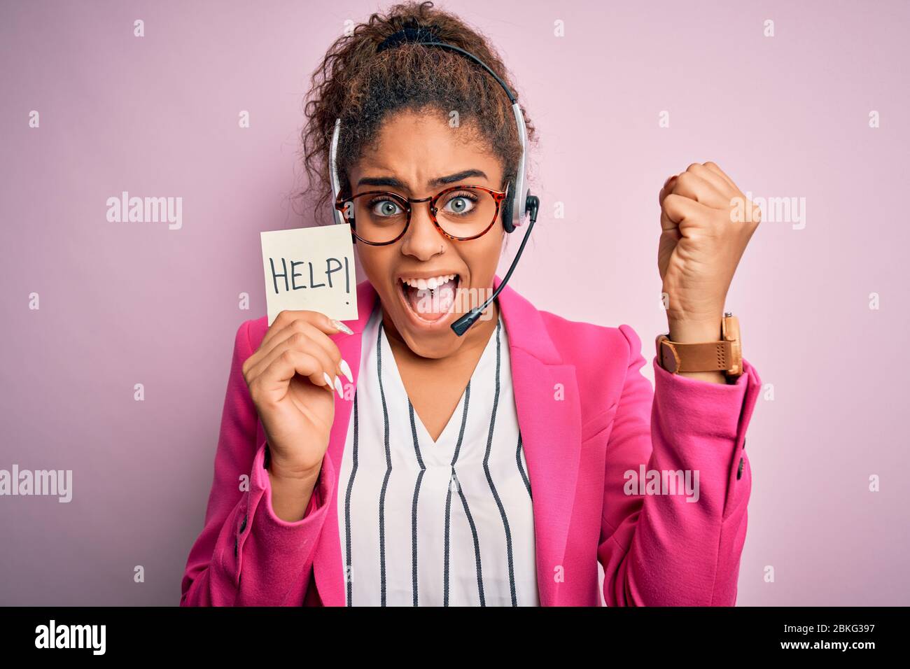 African american call center agent girl using headset holding reminder ...