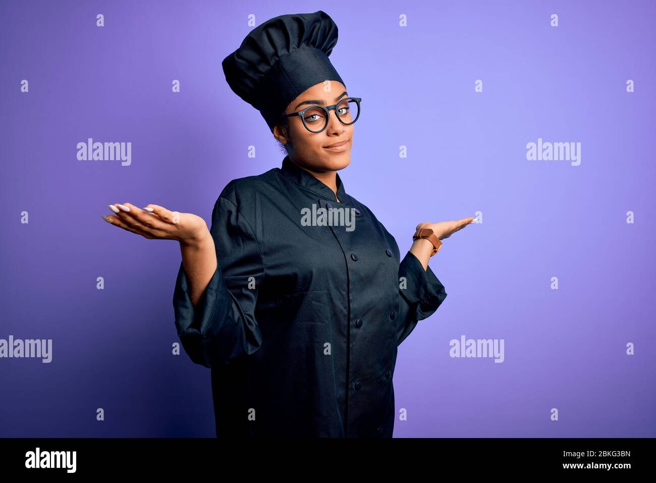 Young african american chef girl wearing cooker uniform and hat over ...