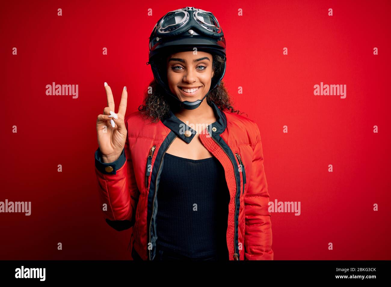 Young african american motorcyclist girl wearing moto helmet and ...