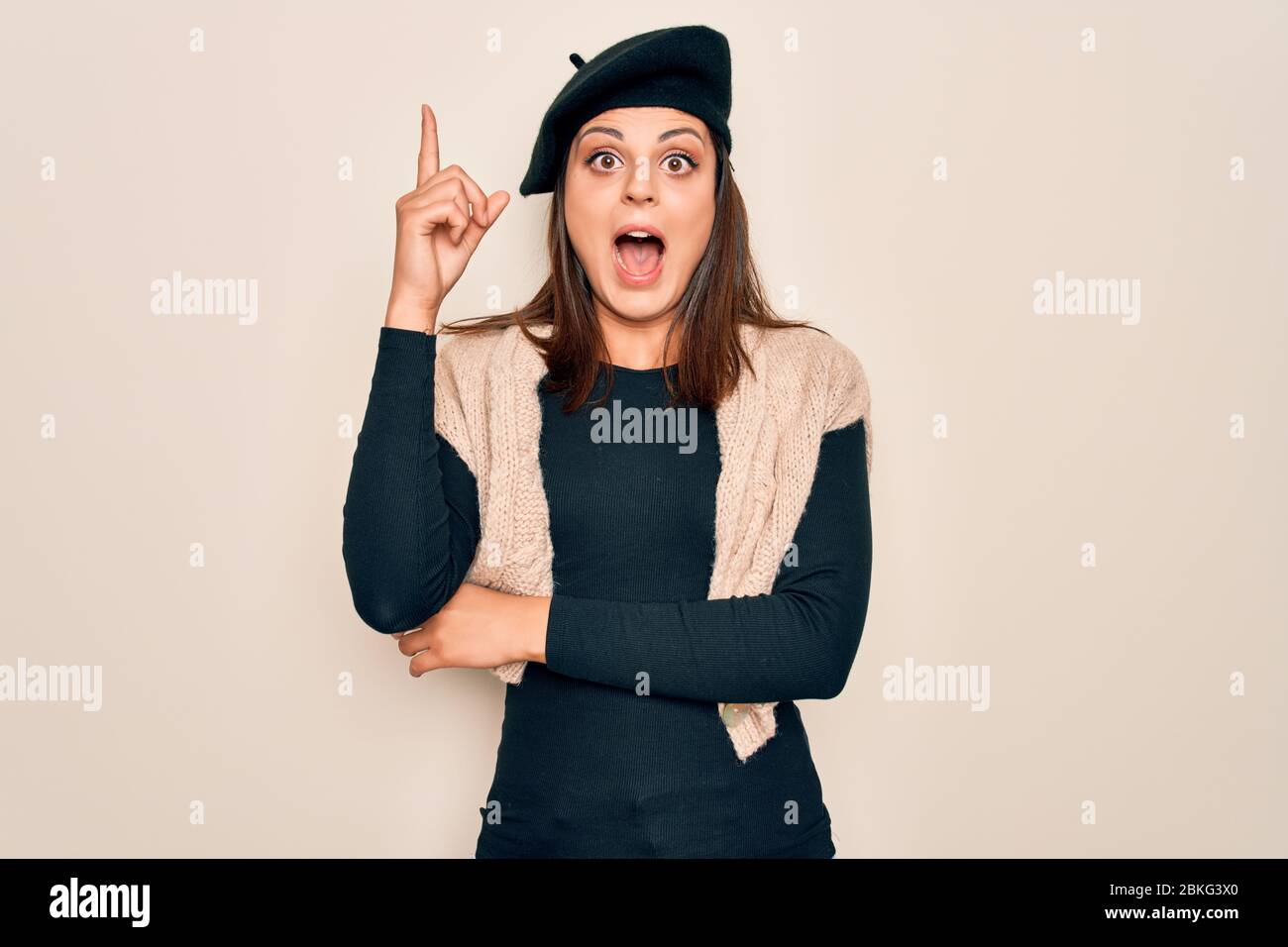 Young beautiful brunette woman wearing casual french beret over white ...