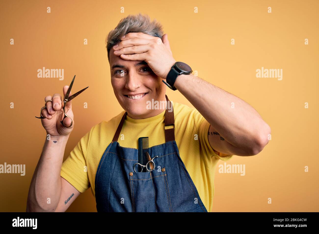 Young modern professional hairdresser man holding scissors over ...
