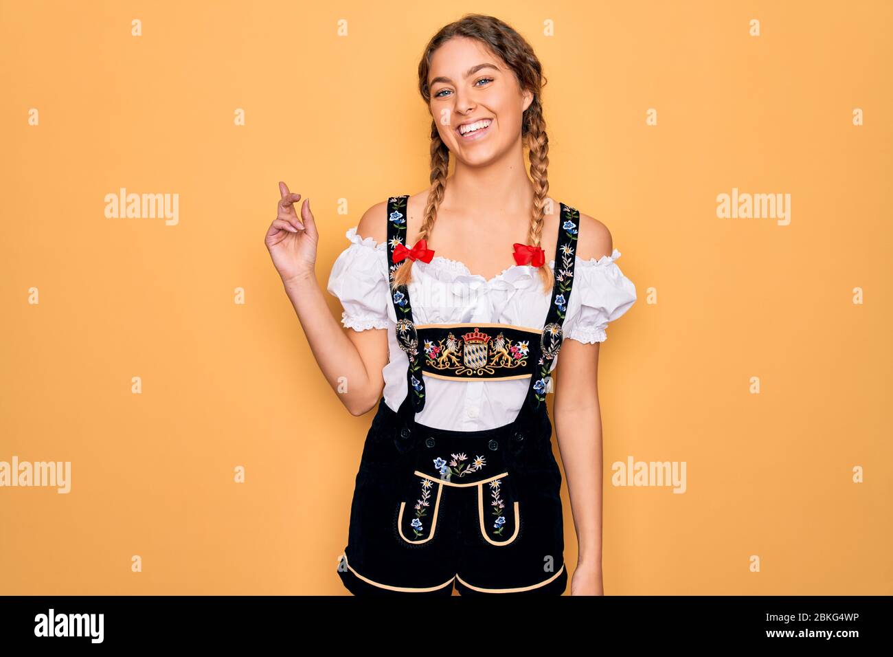 Young beautiful blonde german woman with blue eyes wearing traditional ...