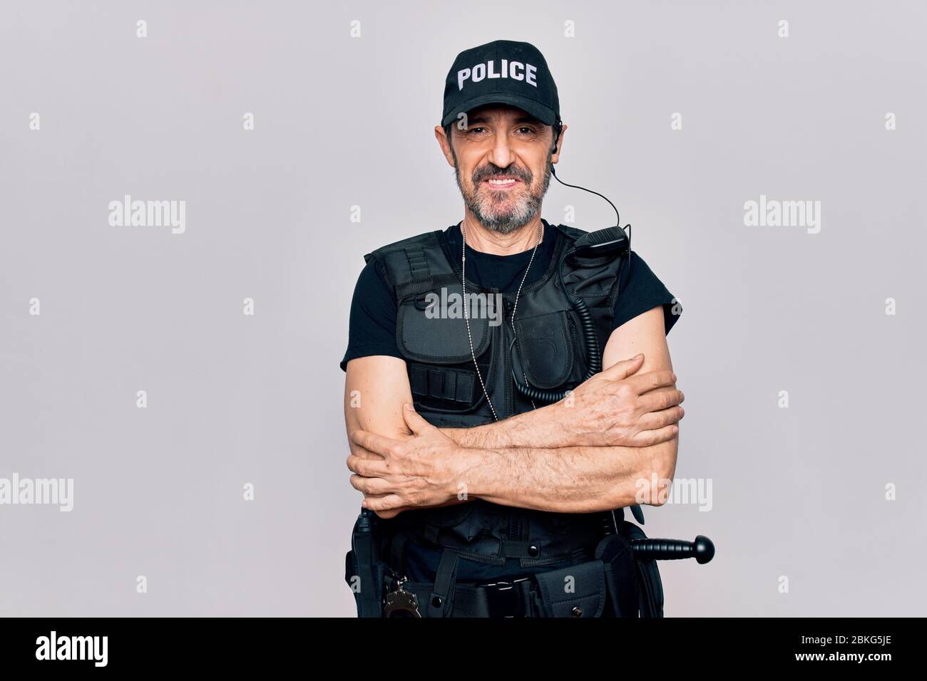 Middle age policeman wearing police uniform and bulletproof vest over ...