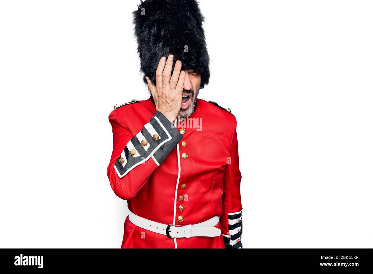 Middle age handsome wales guard man wearing traditional uniform over ...