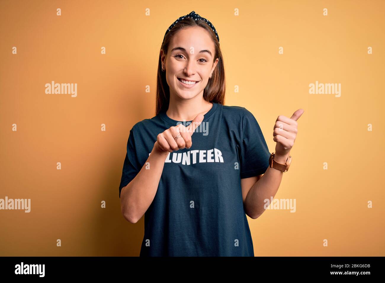 Young beautiful woman wearing volunteer t-shirt doing volunteering over ...