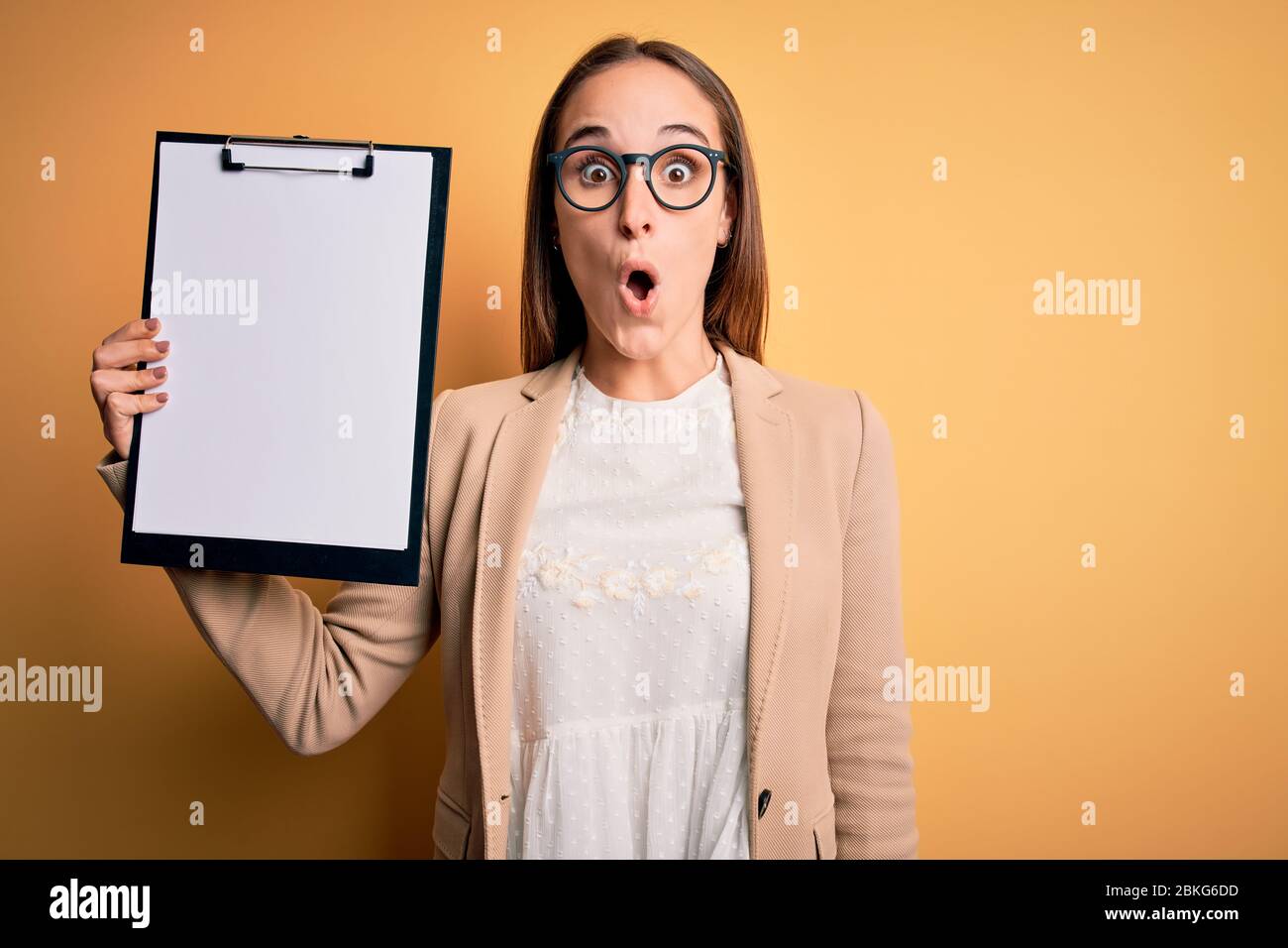 Beautiful inspector woman wearing glasses holding checklist clipboard ...