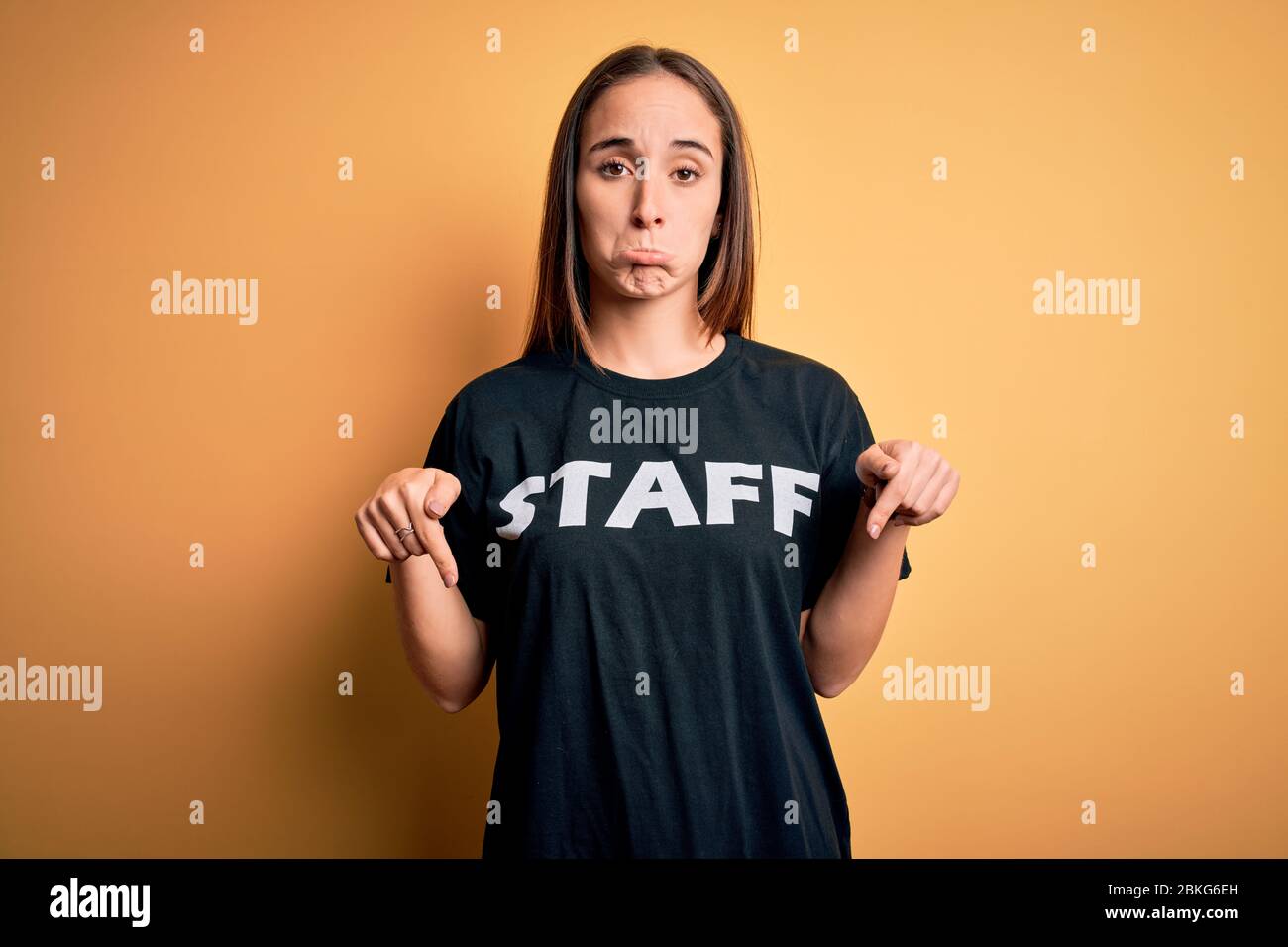 Young beautiful worker woman wearing staff uniform t-shirt over ...