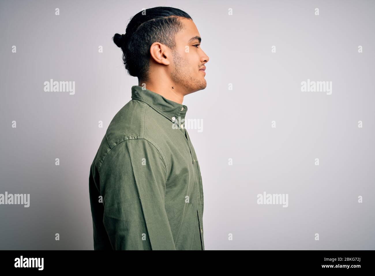 Young brazilian man wearing casual shirt standing over isolated white ...