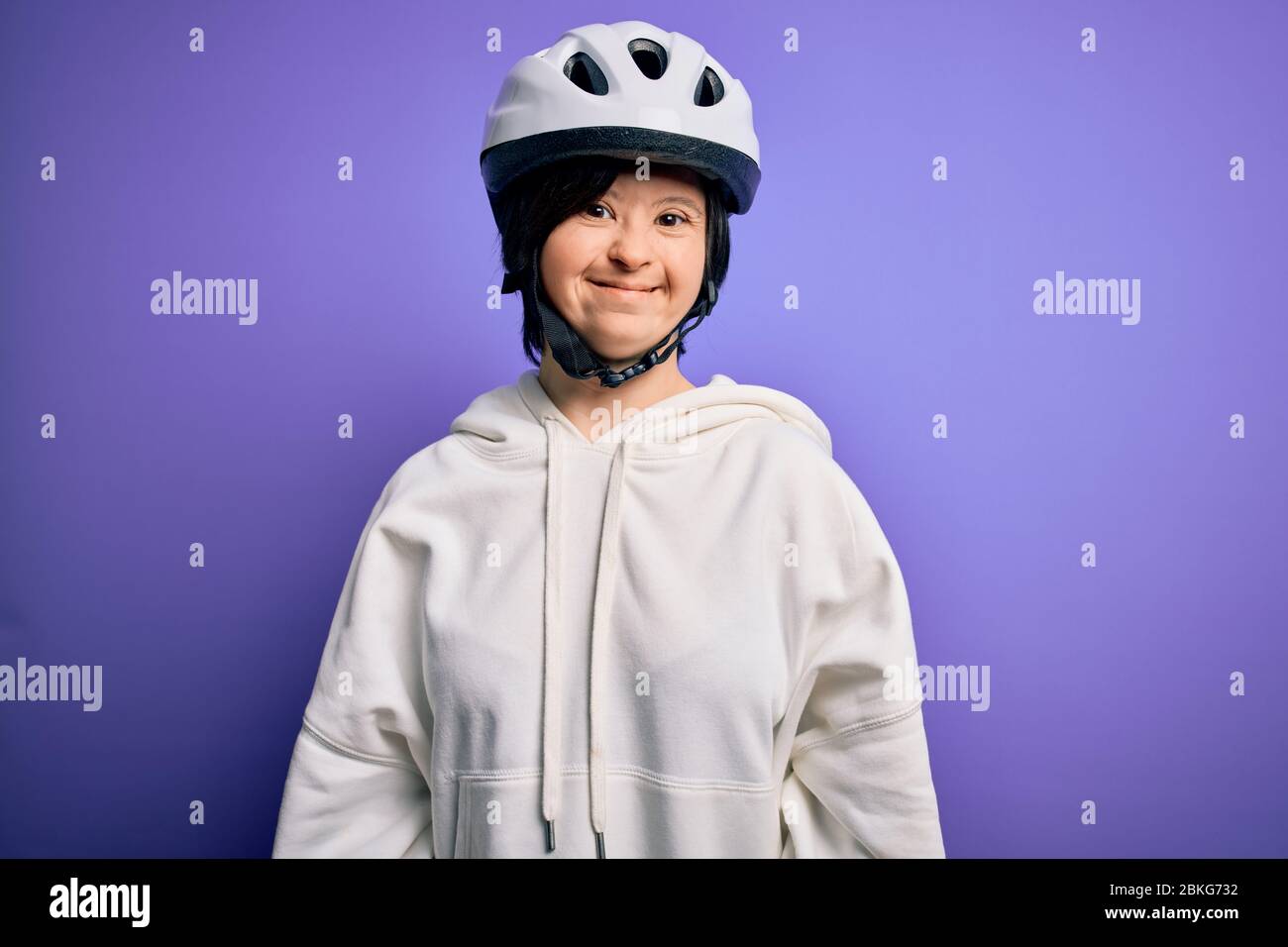 Young down syndrome cyclist woman wearing security bike helmet over ...
