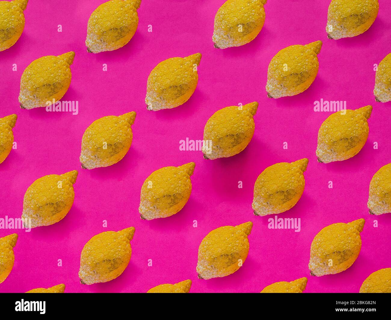 Rotten lemon pattern on strong pink background Stock Photo - Alamy