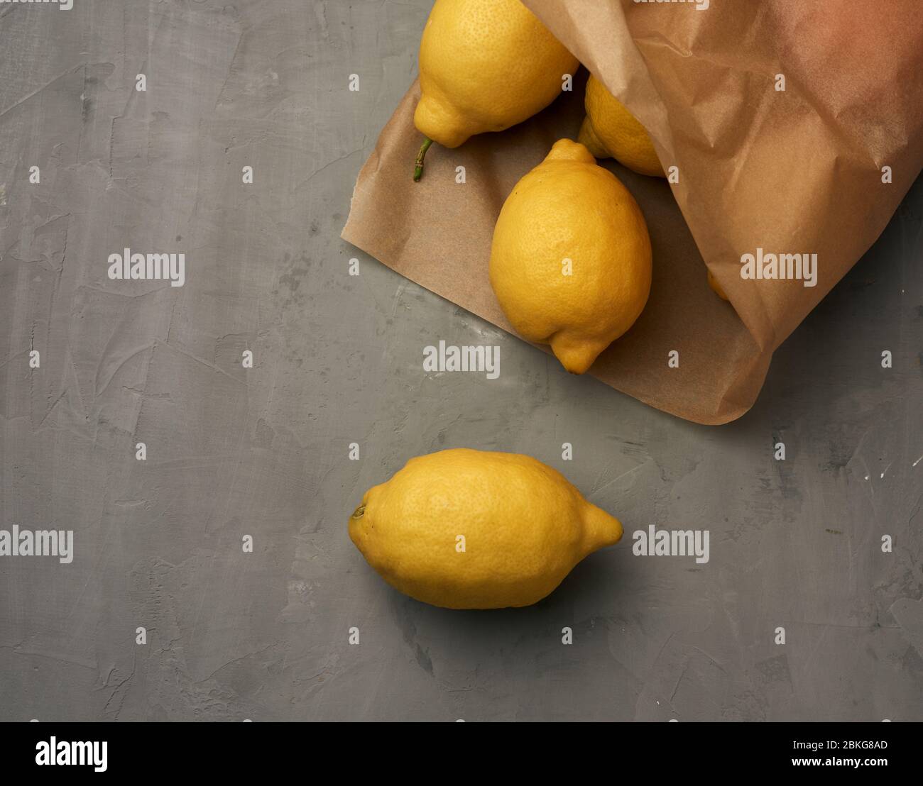 ripe yellow lemons on a gray table, ingredient for lemonade, top view ...