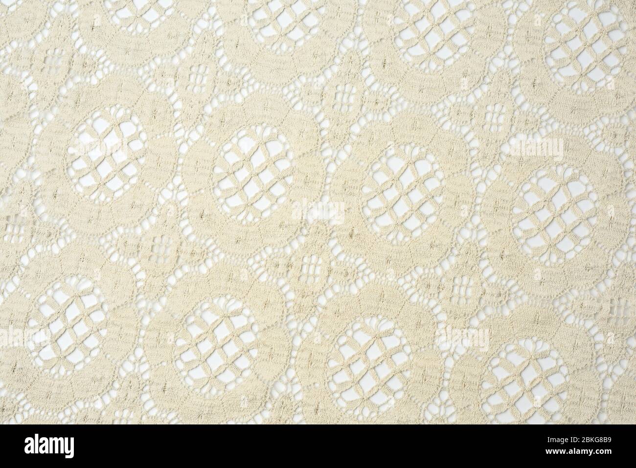 texture of beige synthetic fabric guipure for sewing clothes, full ...