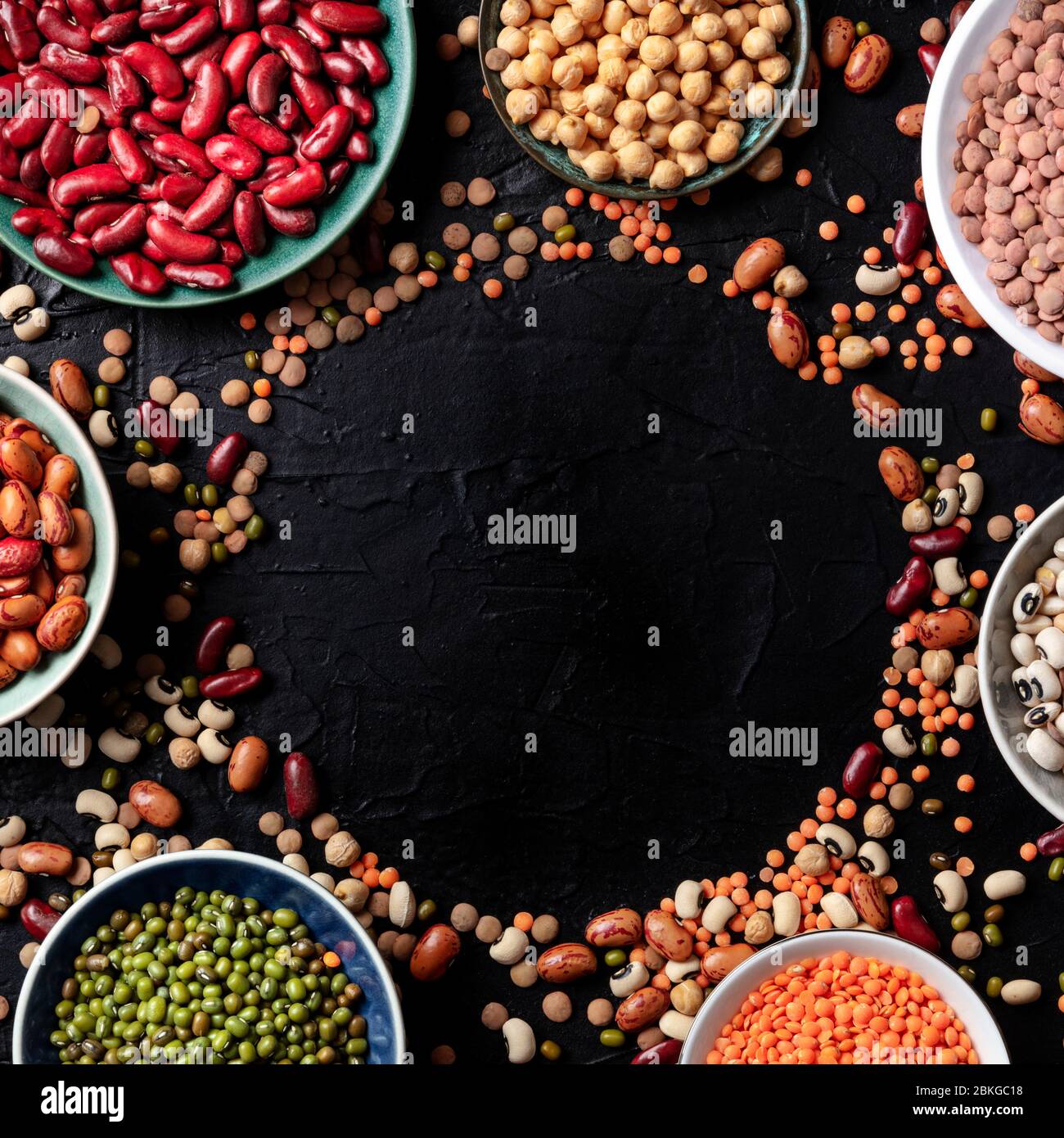 Legumes assortment, shot from above on a dark background with copy ...