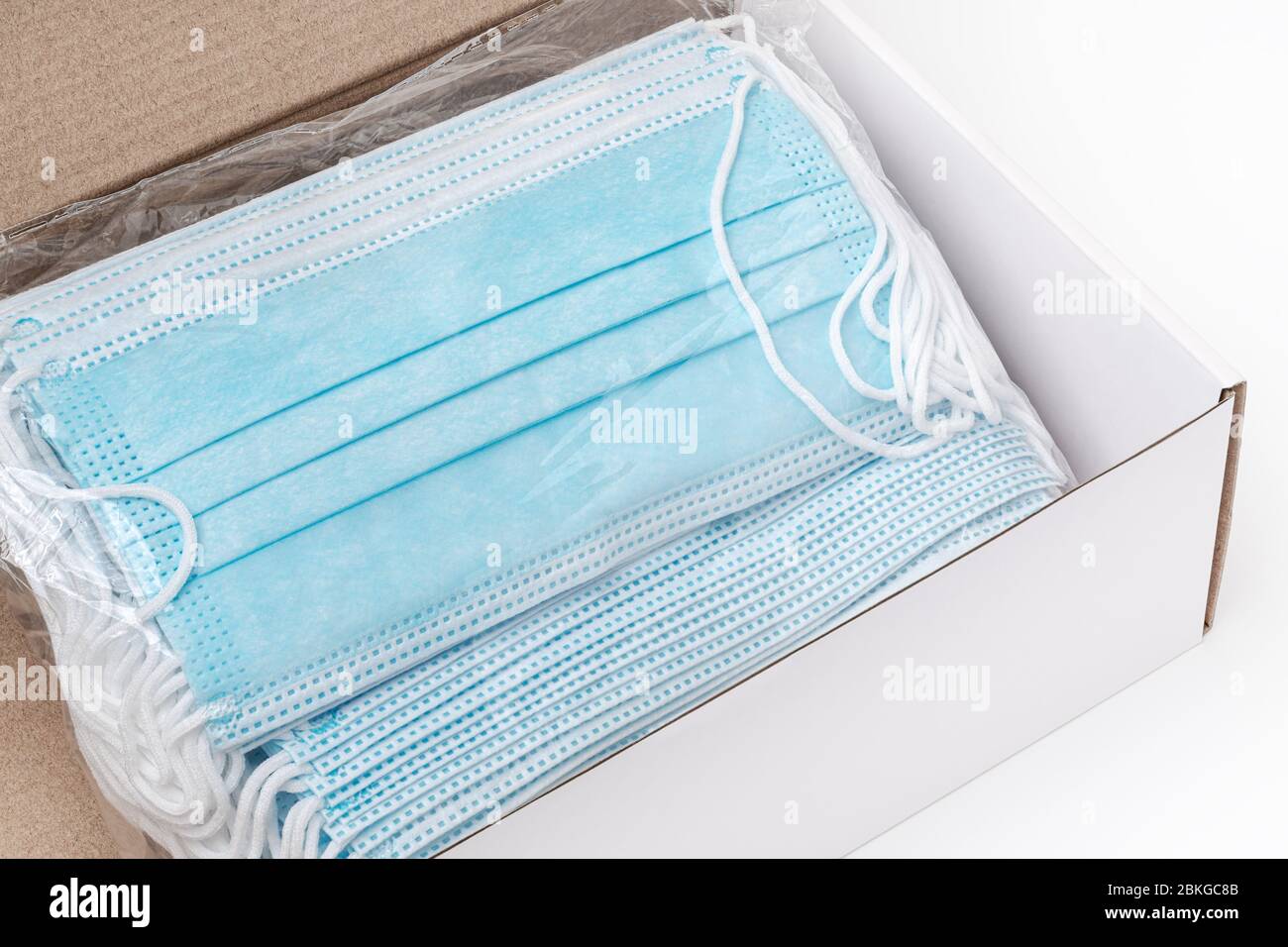 Package of surgical face masks with rubber ear straps in cardboard box ...