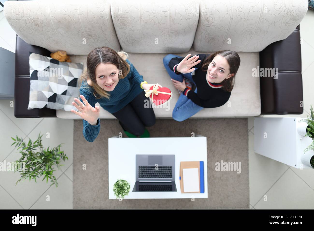 Smiling happy ladies waving hello Stock Photo - Alamy