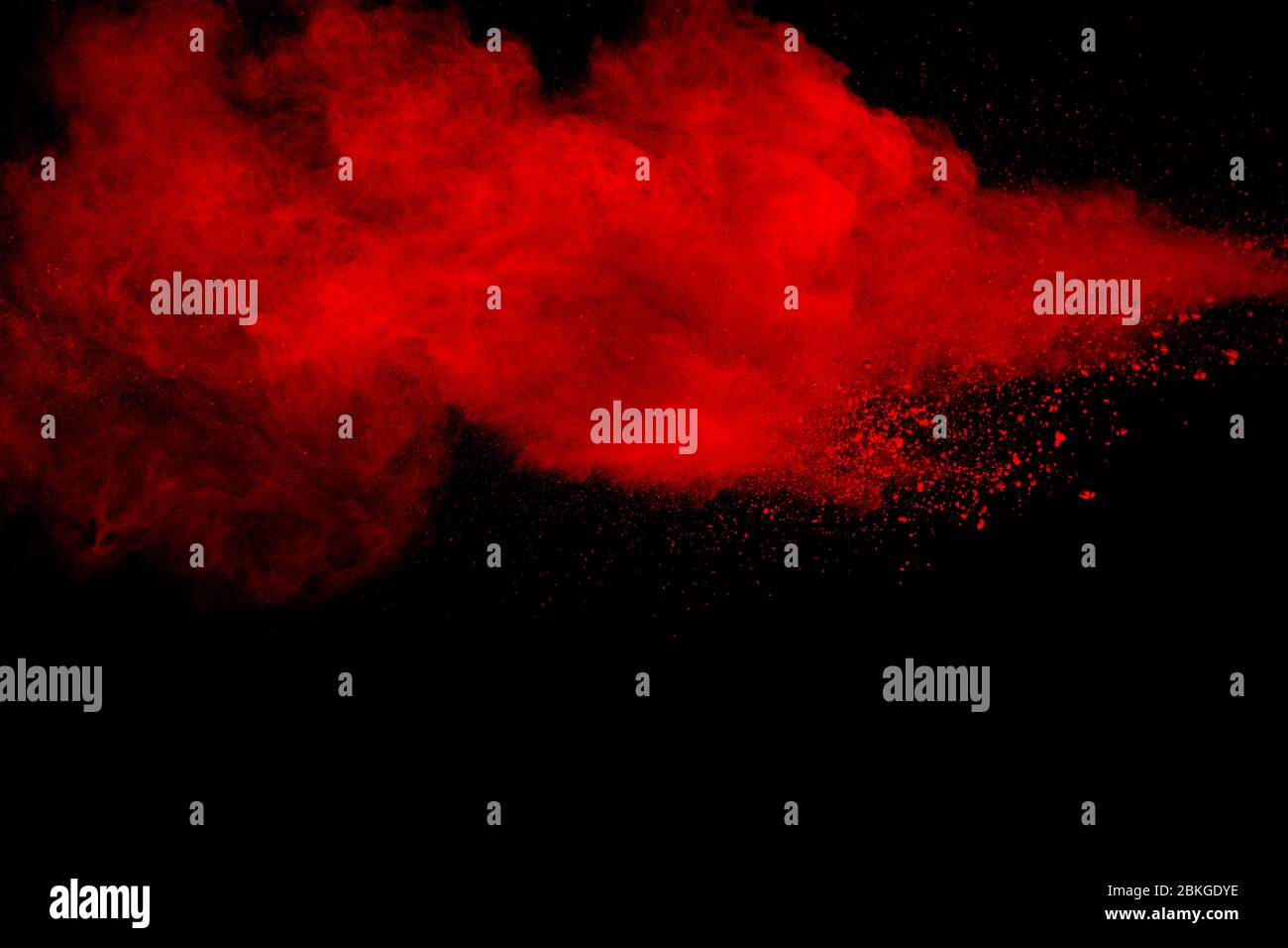 Red particles explosion on black background. Freeze motion of red dust ...