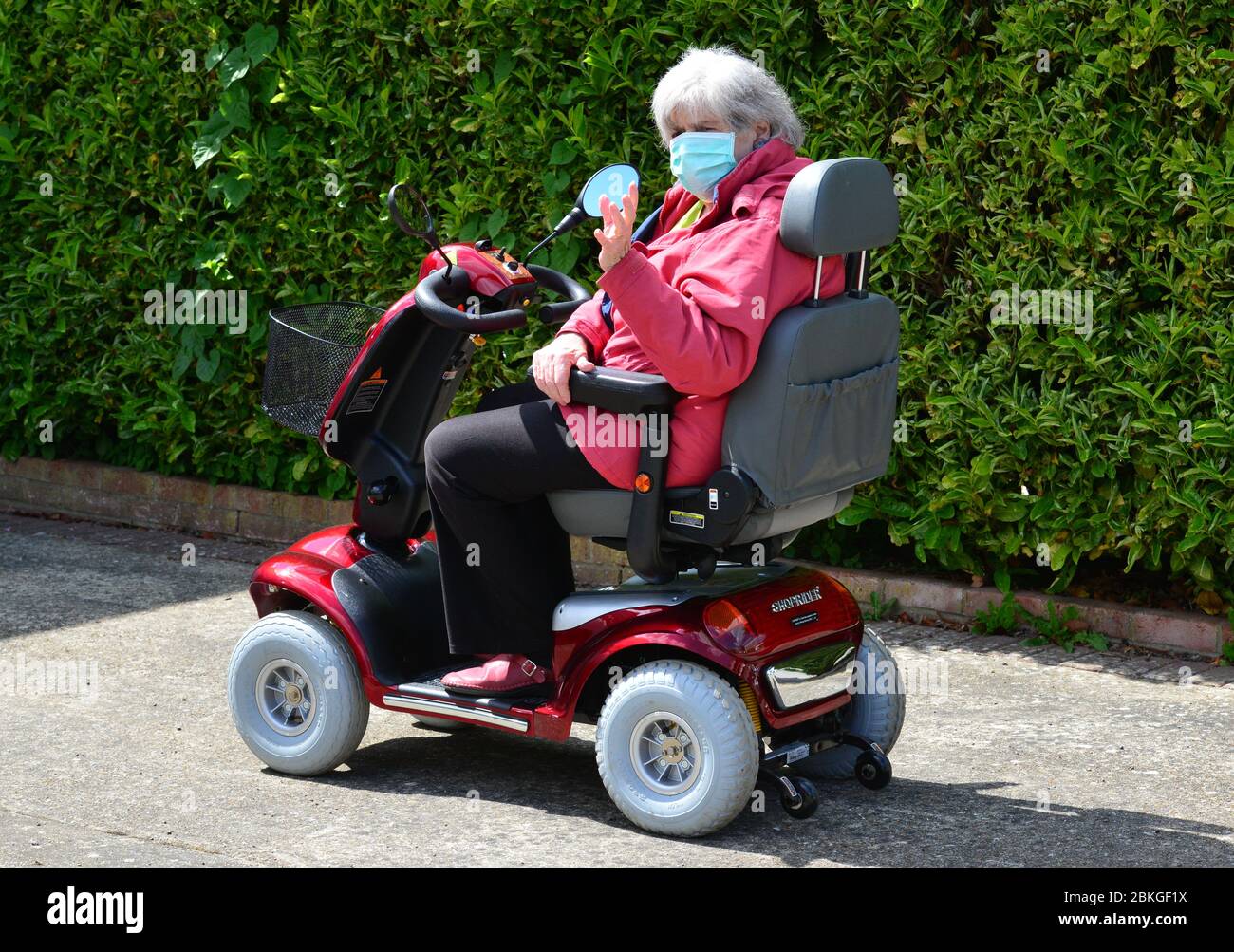 A Lady on a mobility scooter wearing PPE during the Covid-19 Lockdown ...