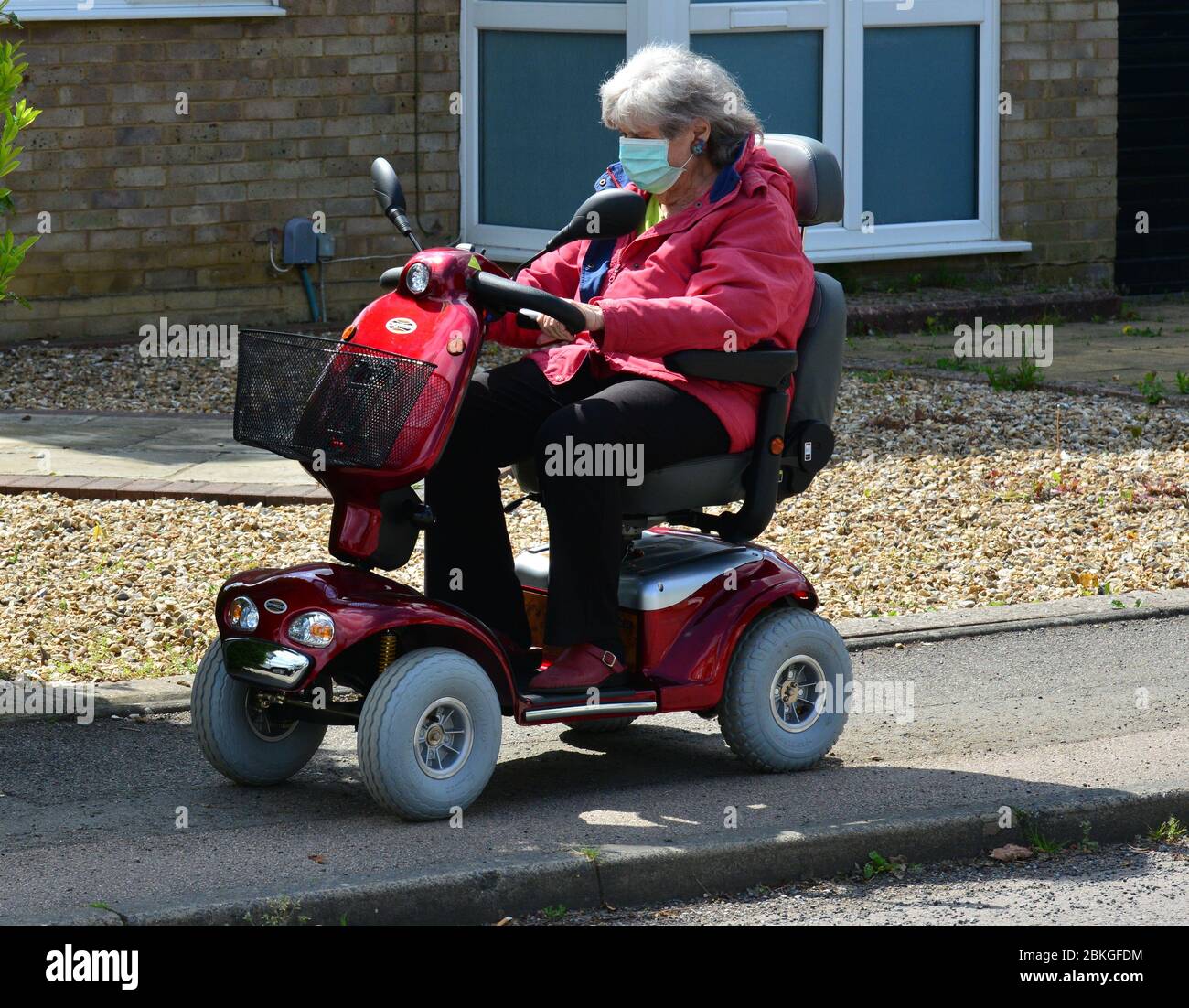 A Lady on a mobility scooter wearing PPE during the Covid-19 Lockdown ...