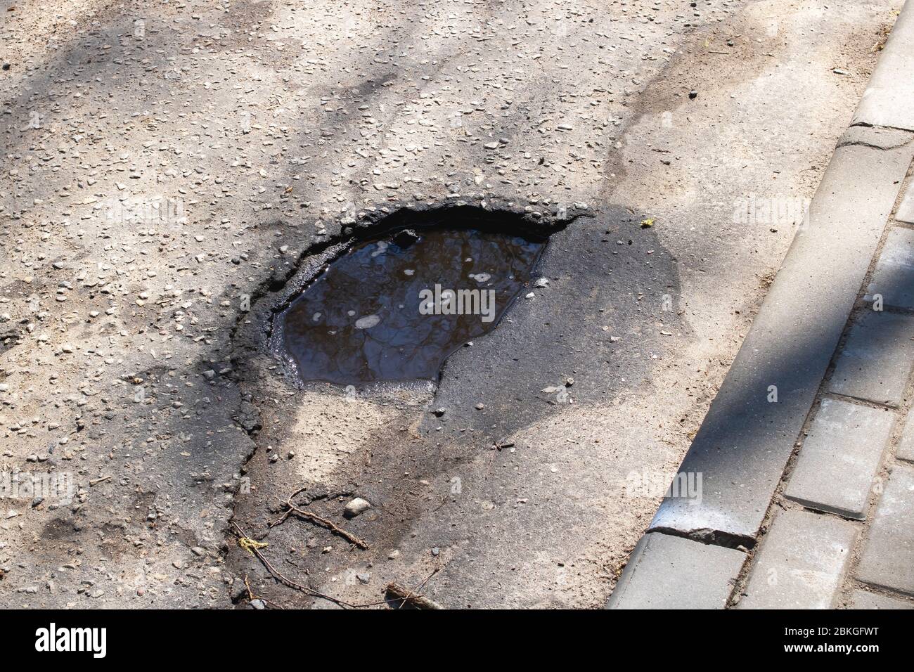 Hole in the pavement on the road Stock Photo - Alamy