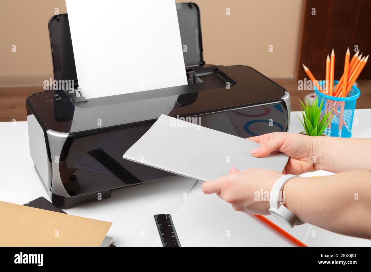 Woman using the printer to scanning and printing document Stock Photo ...