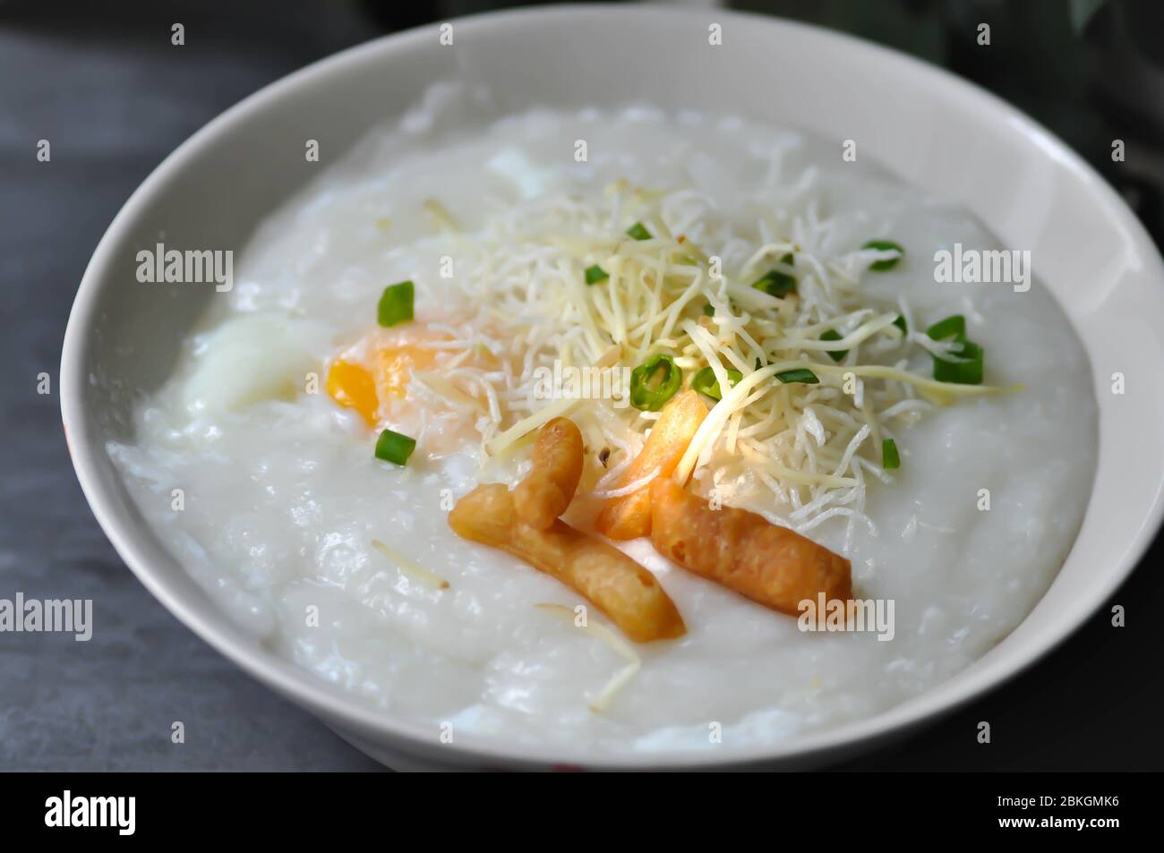 rice gruel, rice porridge or congee with egg and dough Stock Photo - Alamy