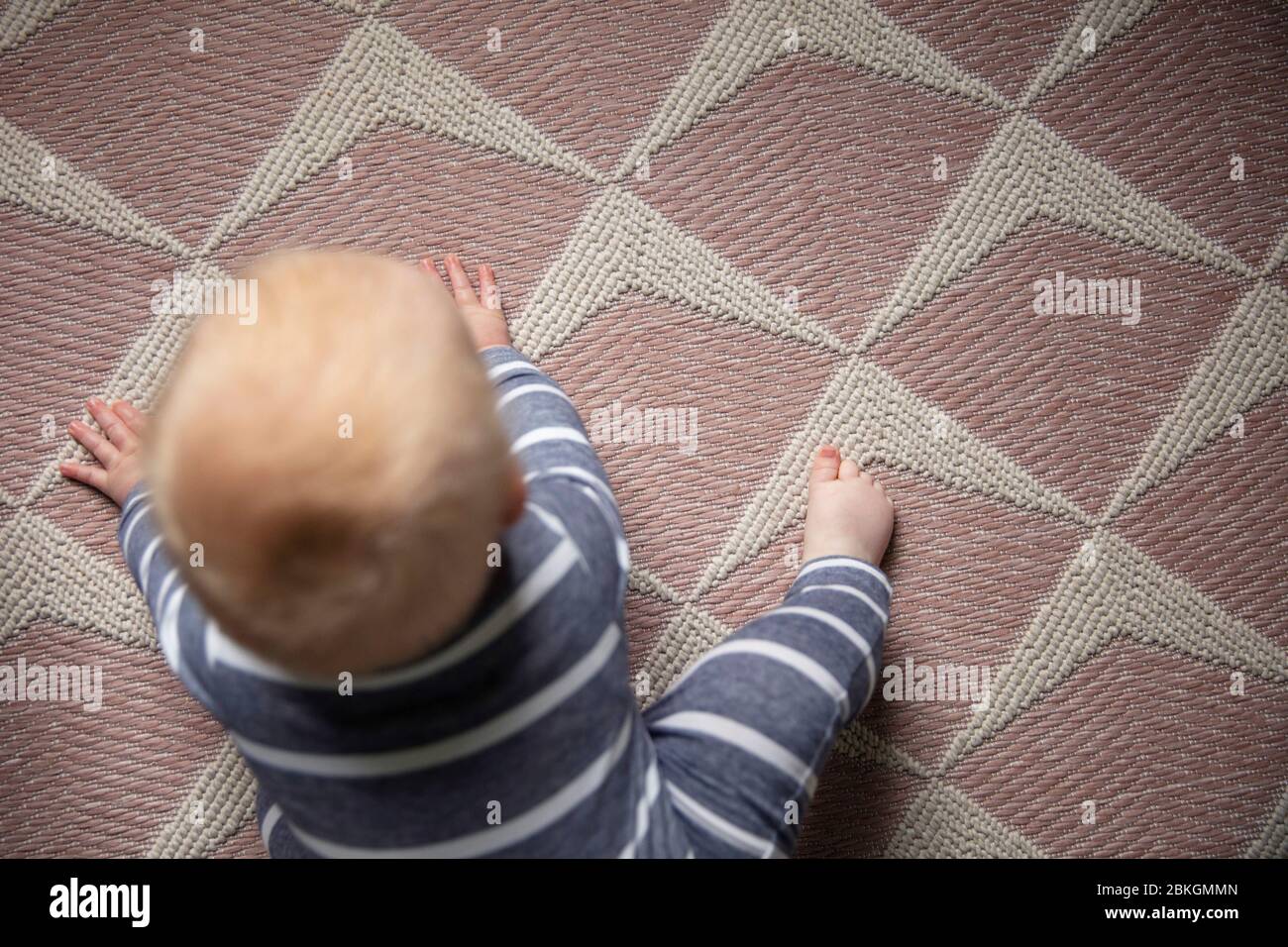 A young baby crawling. Overhead lifestyle baby development Stock Photo ...