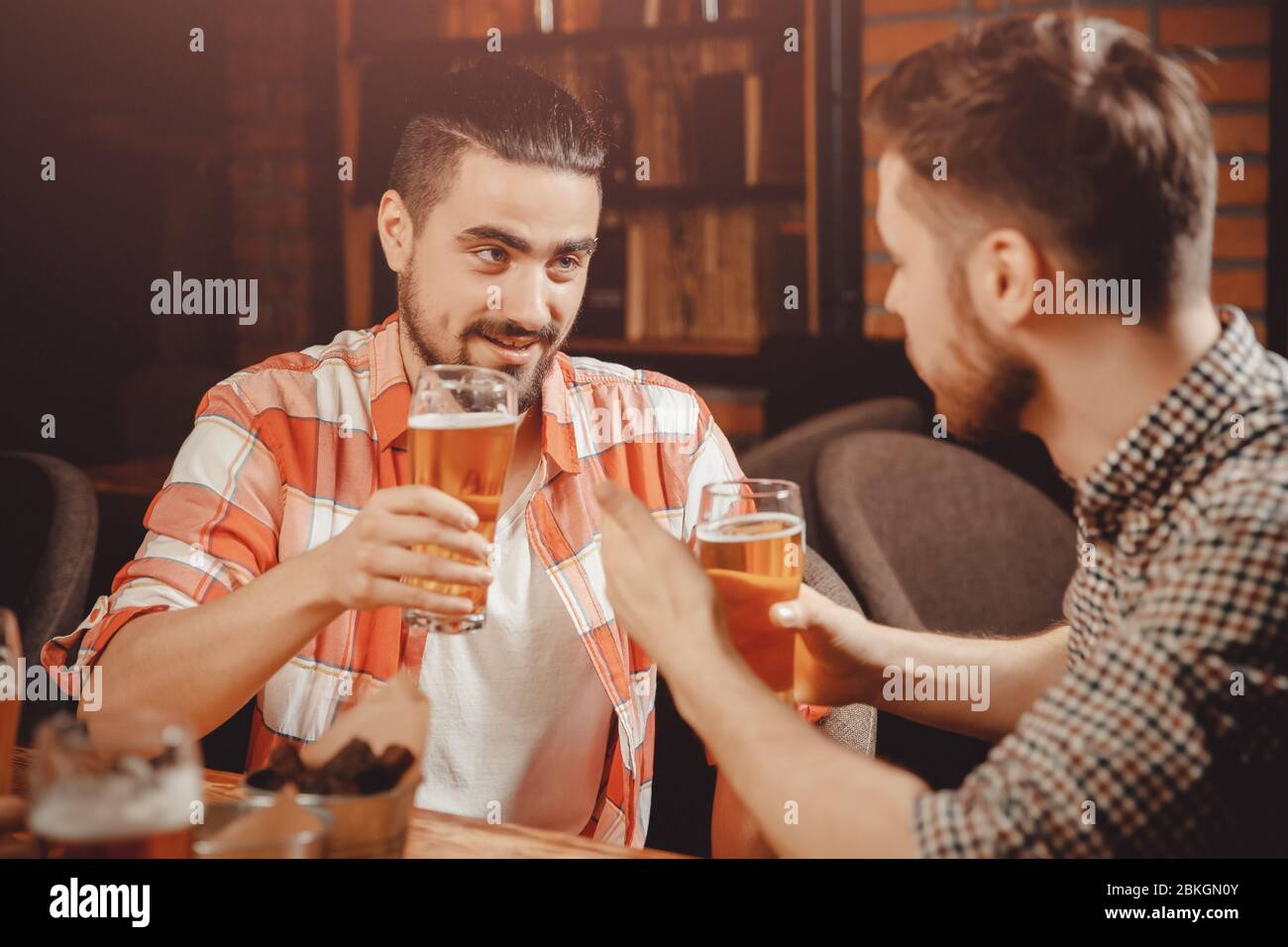 Party in pub, clinking glasses of beer, funny friends laugh Stock Photo ...