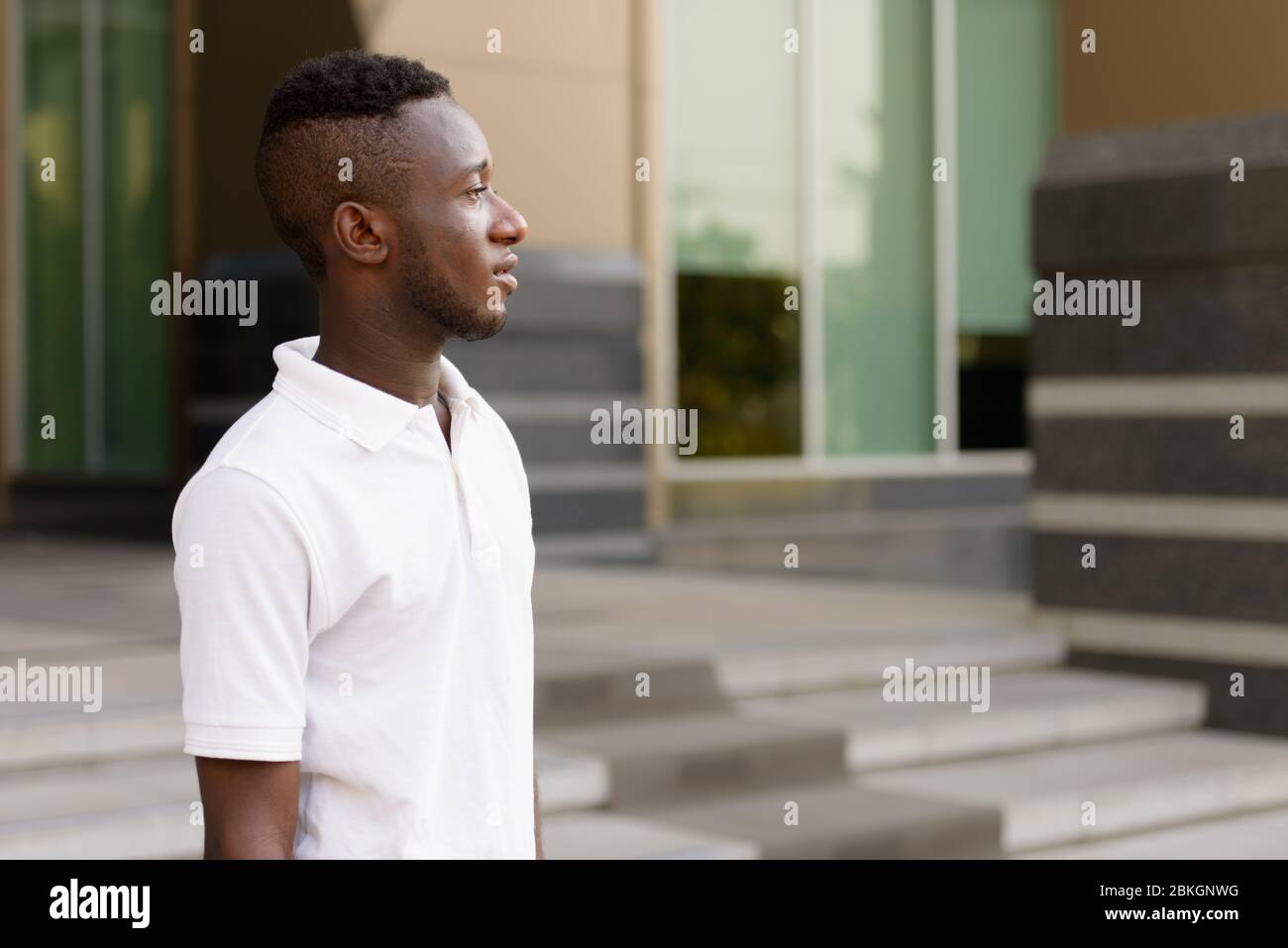 Profile view of young African man in the city outdoors Stock Photo - Alamy