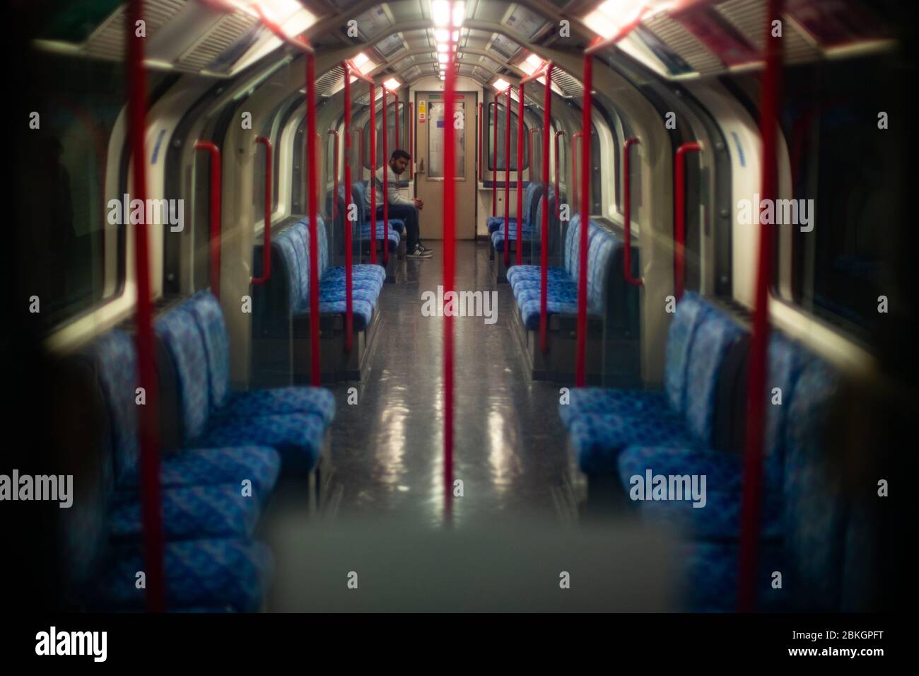 A man sits on in a near empty Central Line carriage as the UK continues ...